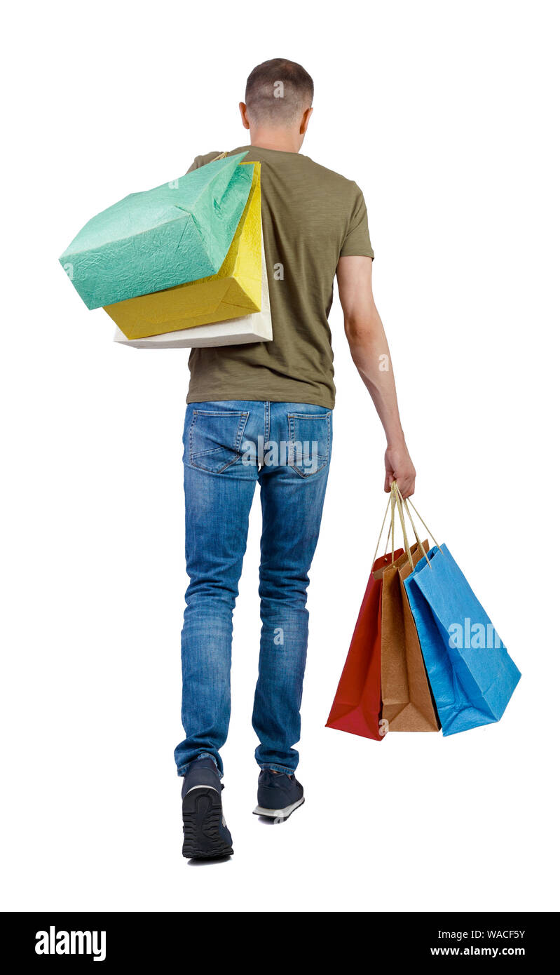 Back view of going man with shopping bags. guy in motion. Rear view ...