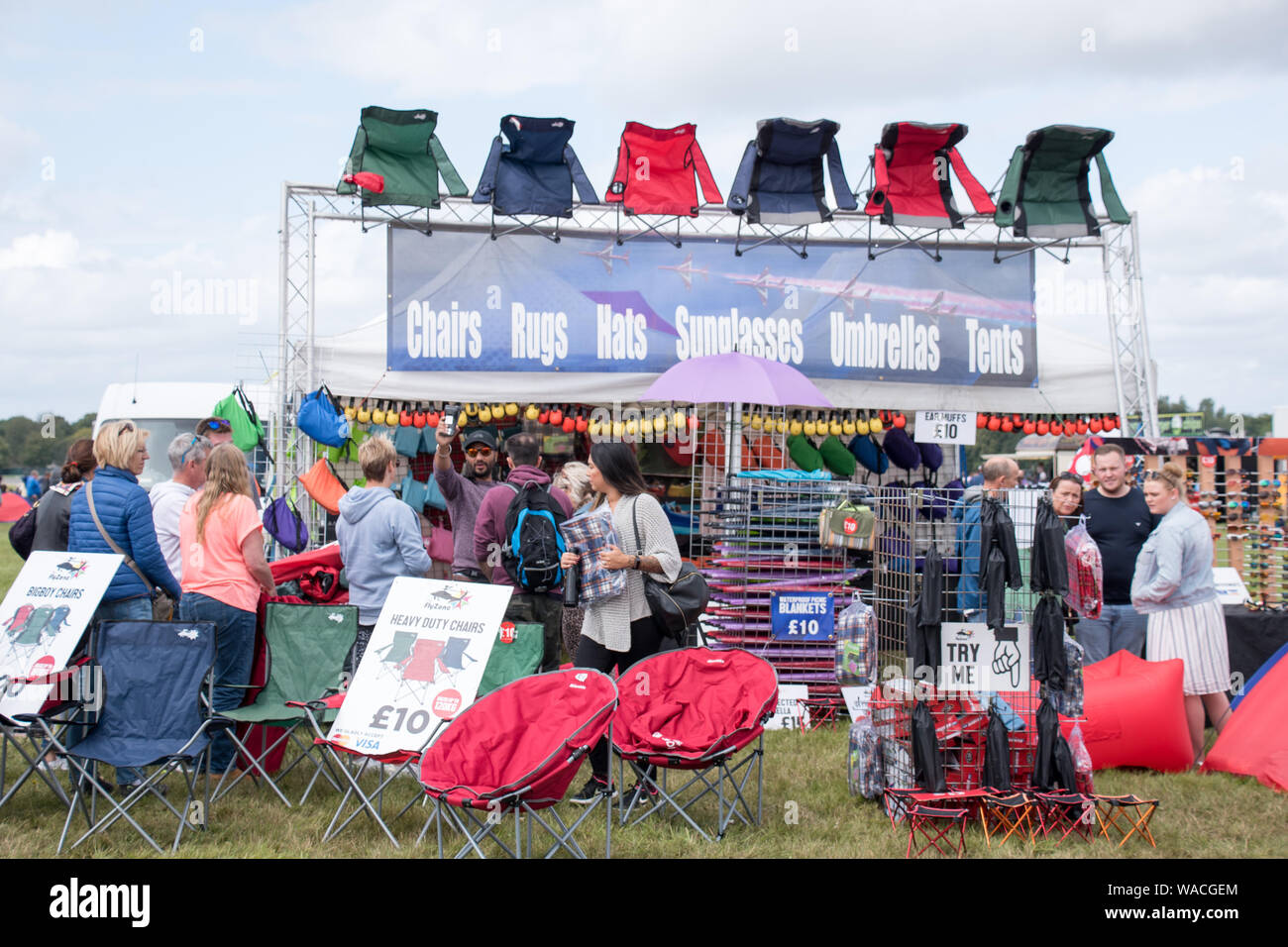 Popup shop - People checking out items on display in open air at an ...
