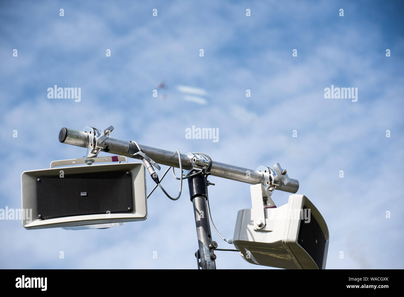 A sound amplifying speaker at airshow with flying display in background ...