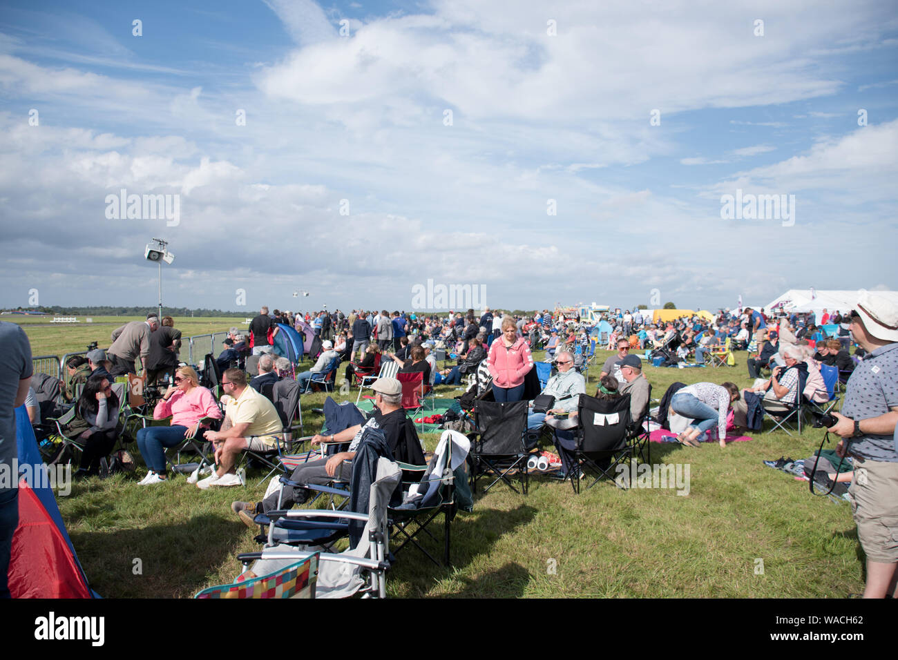 A large crowd of spectators at an airshow behind the fence (EDITORIAL ...