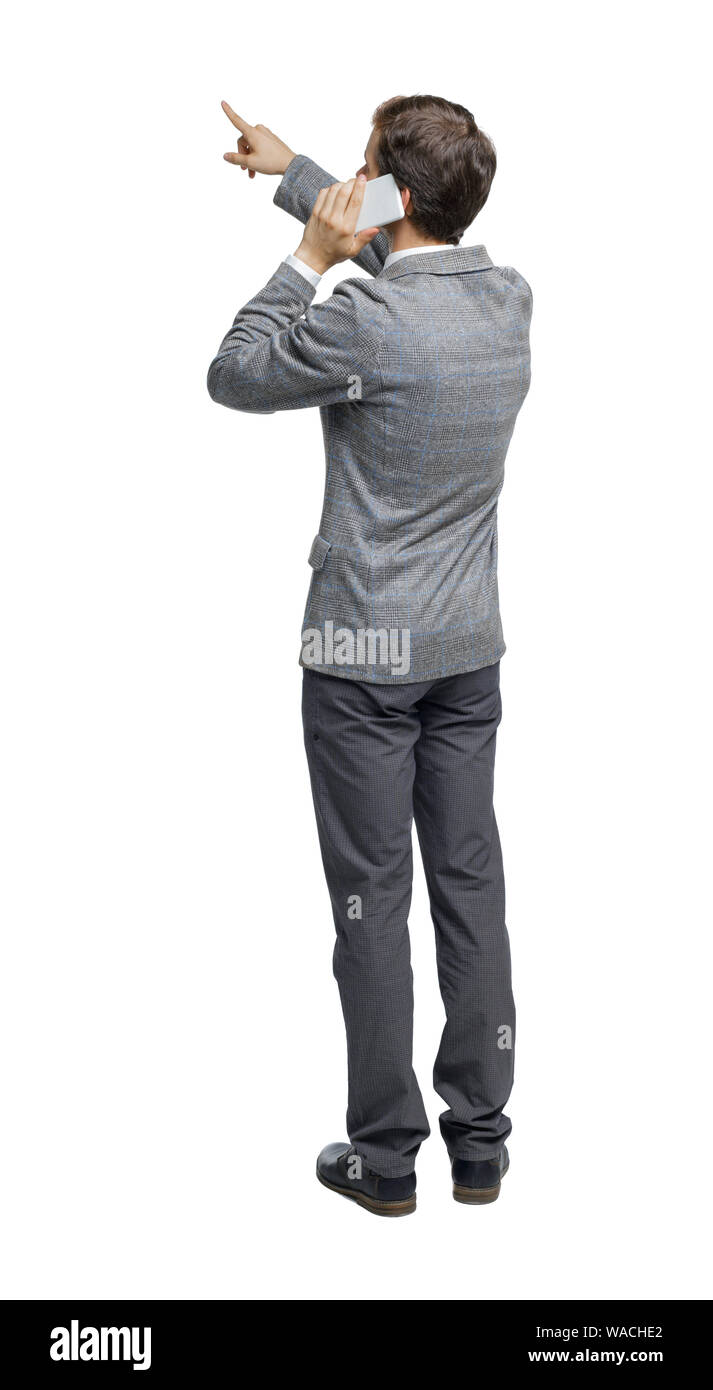 back view of pointing business man in suit talking on mobile phone ...