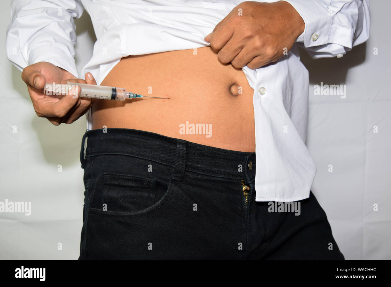 Close up Asian man's hand is making an injection isolated on white ...