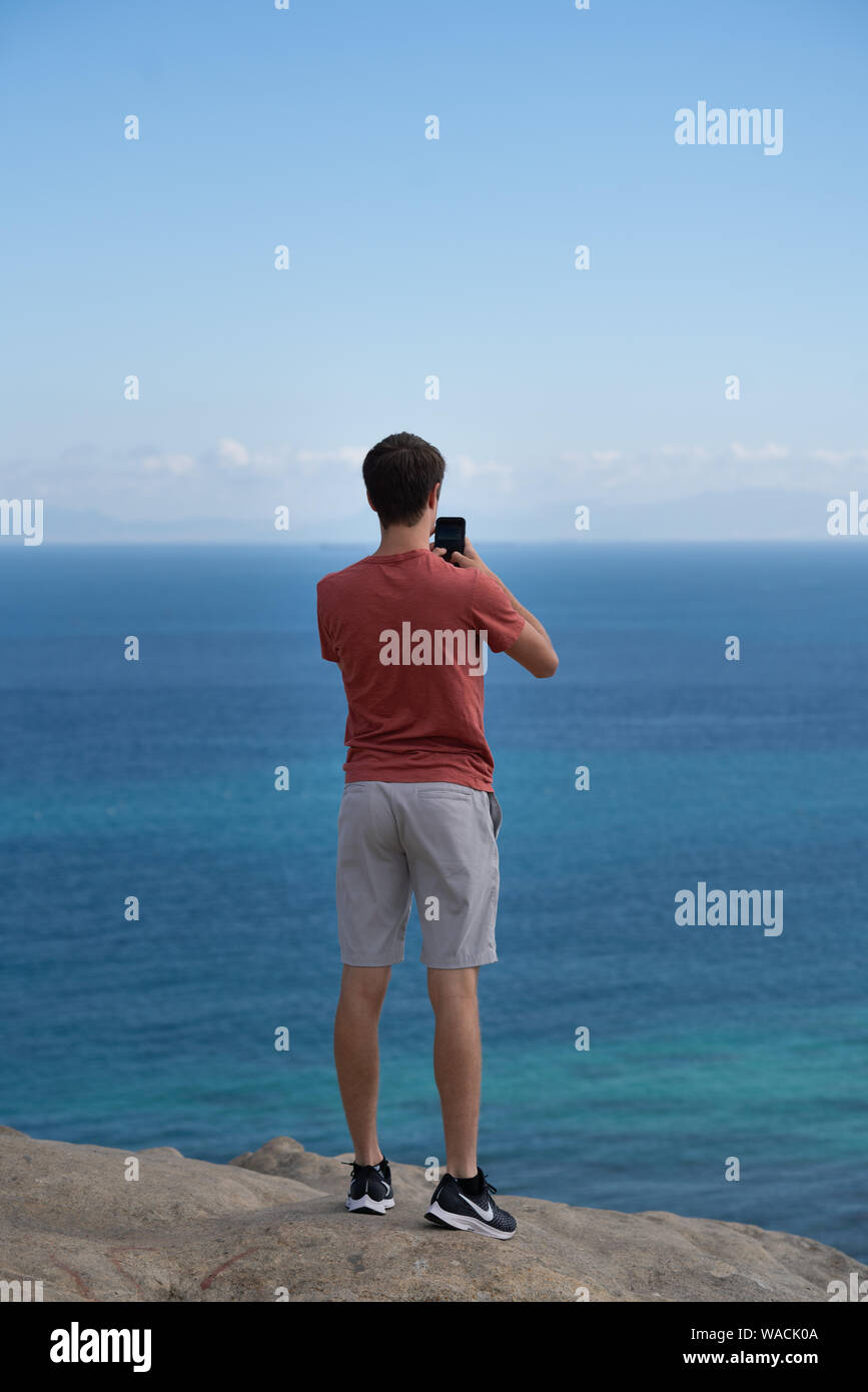 Boy taking a picture of the Straight of Gibraltar, Tangier Stock Photo ...