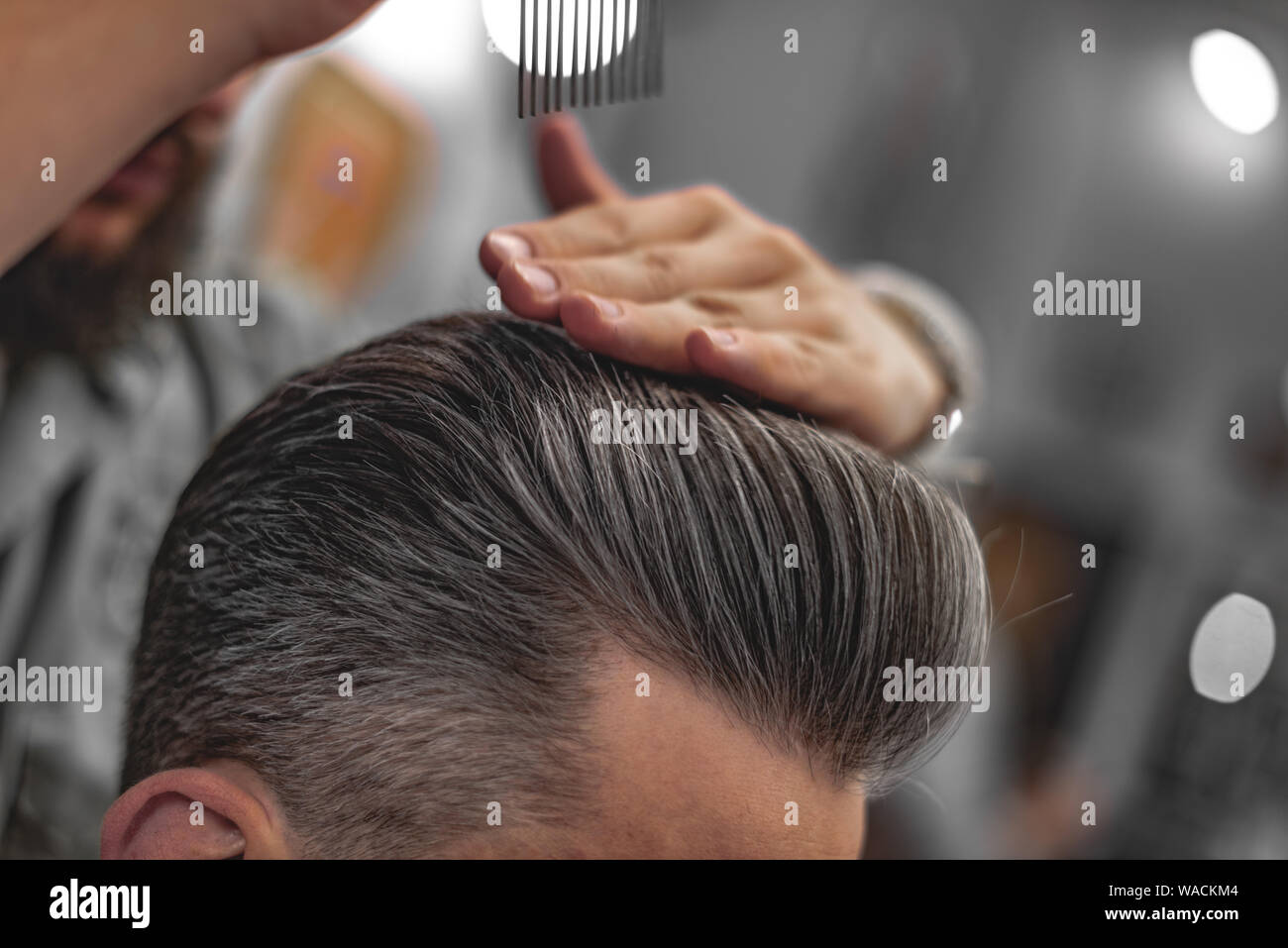 Barber does hair styling. Men's Hair Care Stock Photo - Alamy