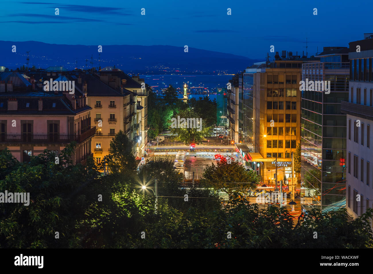 Dusk view of Geneva city streets with buildings, Geneva Lake (Lac Leman ...