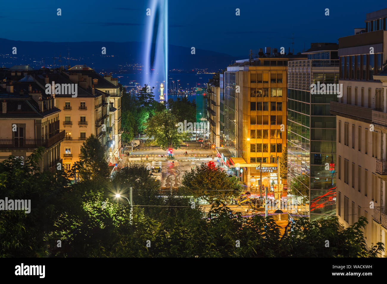 Dusk view of night city streets and illuminated landmark Geneva Water ...