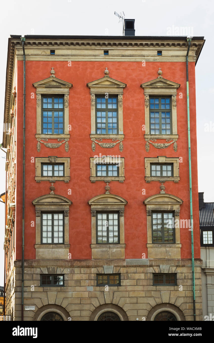 Old baroque architectural style burgundy coloured building with rows of ...