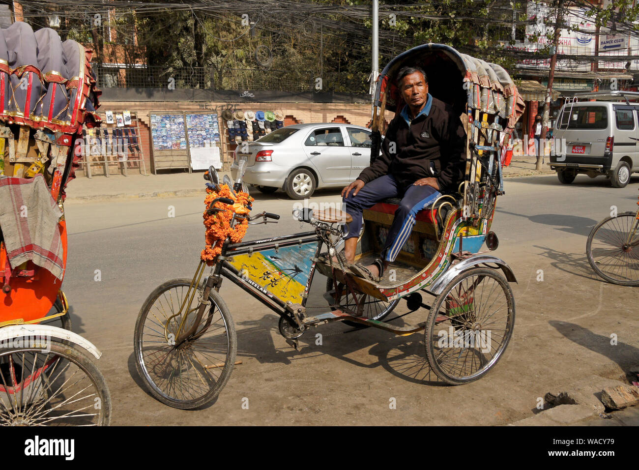 Pedicab driver waiting for passengers on busy street in Thamel district ...