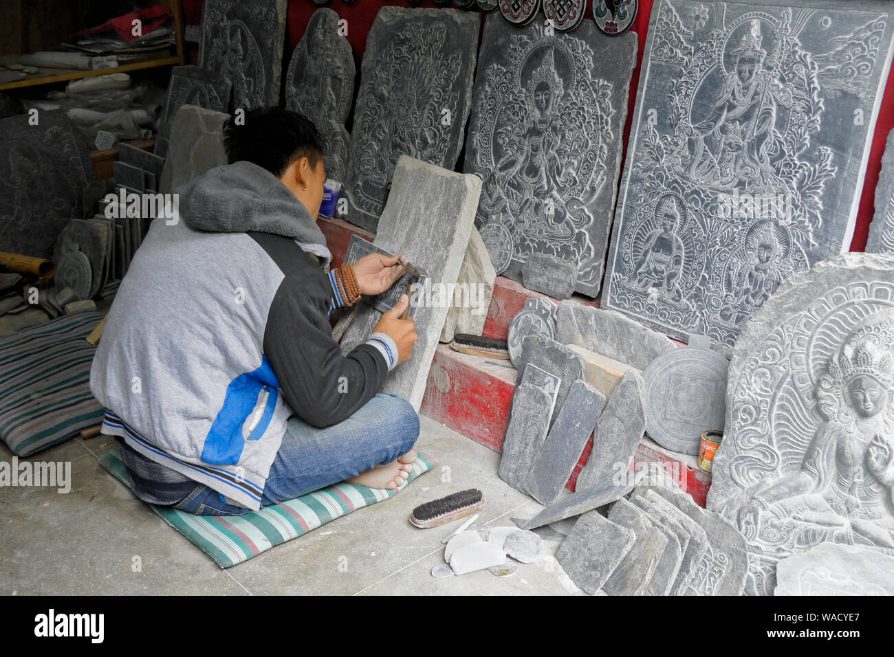 Craftsman in Thamel district of Kathmandu, Nepal, carving stone ...