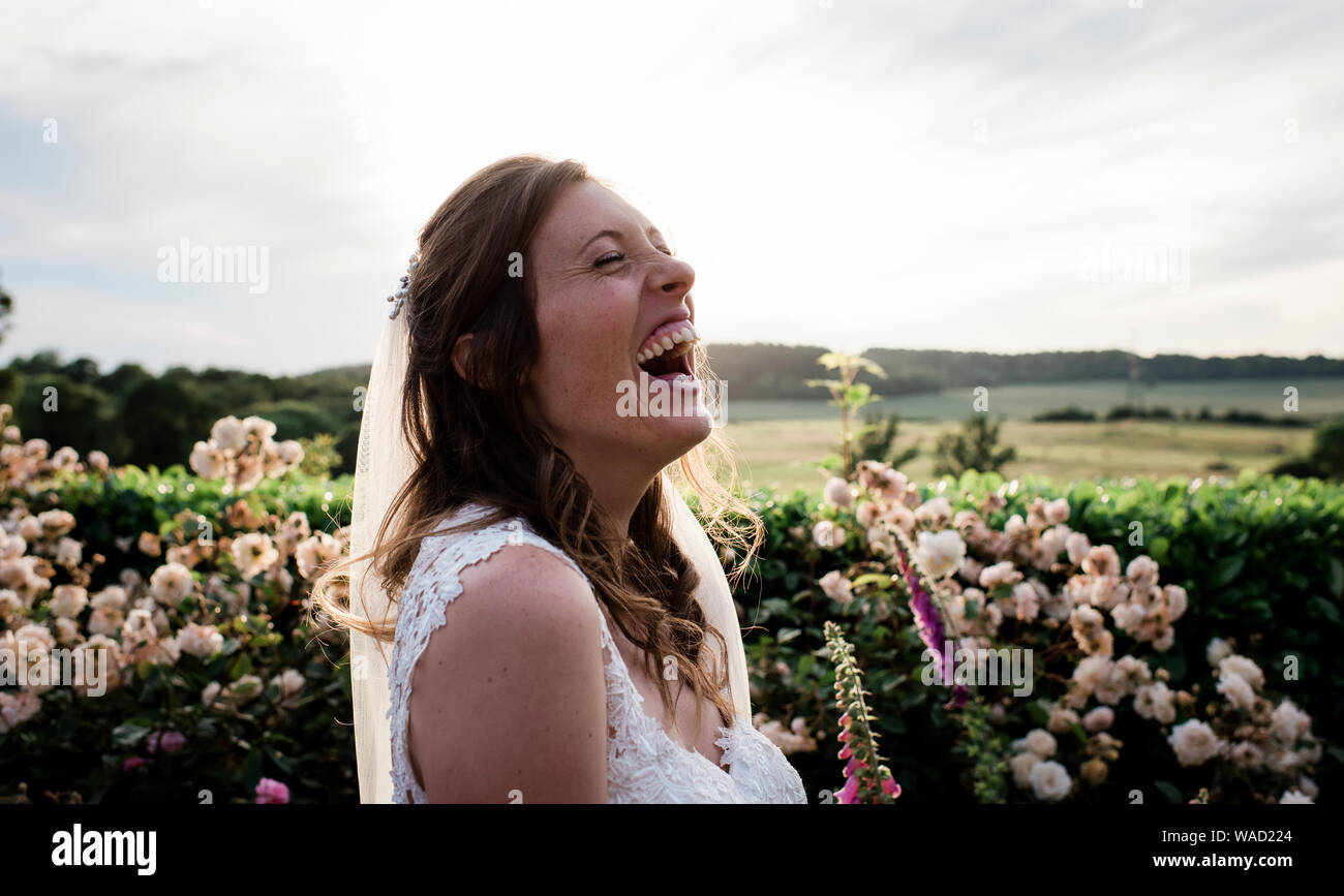 bride on her wedding day laughing Stock Photo - Alamy