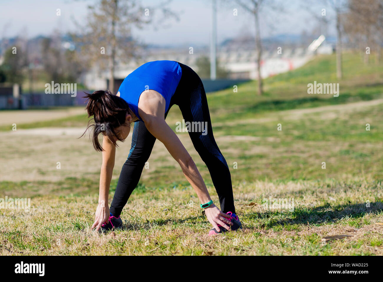 Woman stretching during preparation for a workout Stock Photo - Alamy