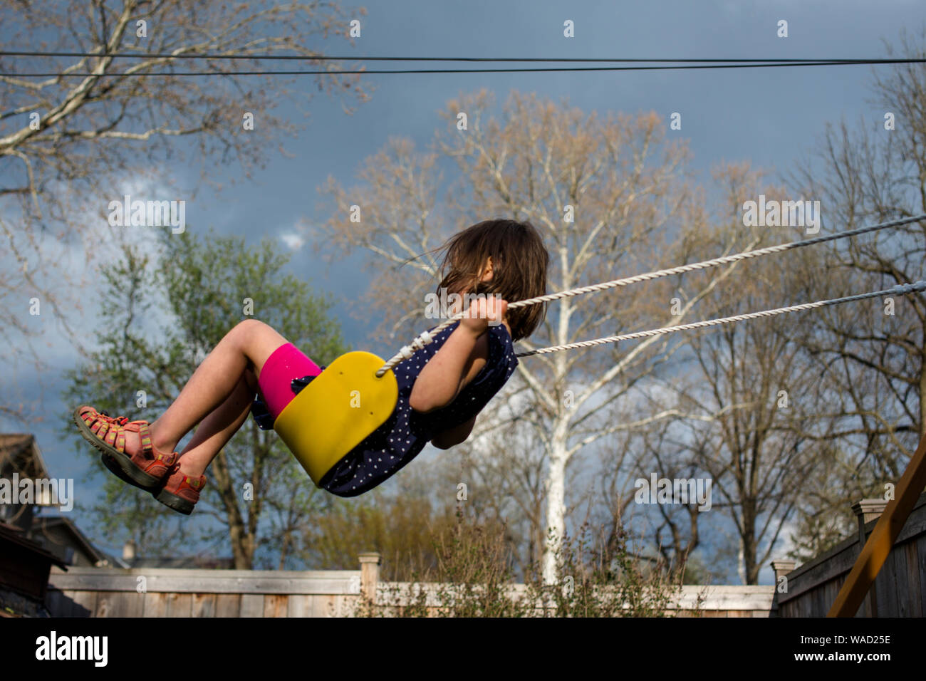 Little girl on the swing hi-res stock photography and images - Alamy