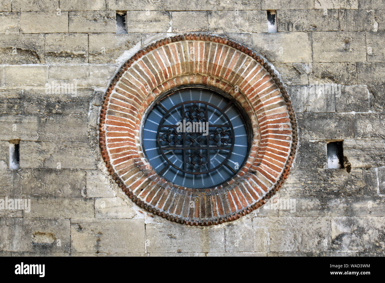 Circle window on church exterior with stone facade Stock Photo - Alamy