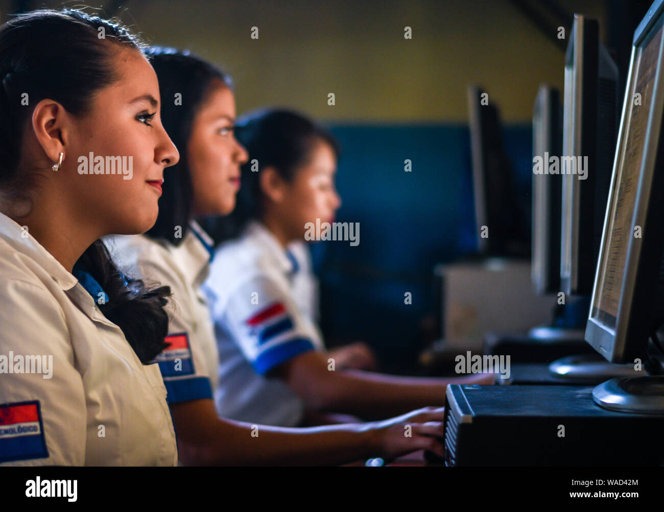 latin female students working on computers at college in Guatemala ...