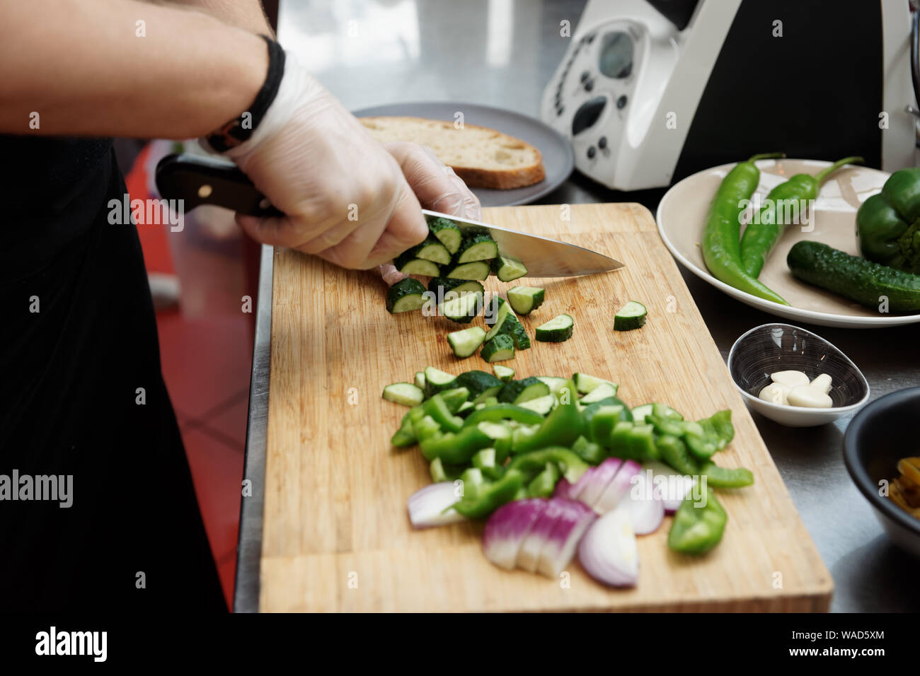 Chef is cutting vegetables at commercial kitchen Stock Photo - Alamy