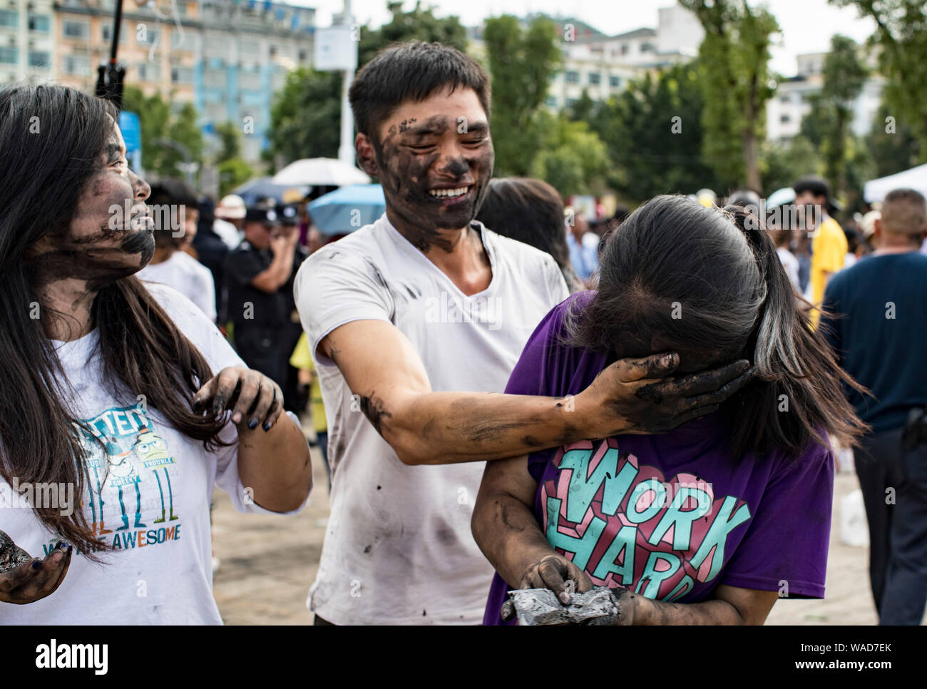 Chinese people of the Yi ethnic group daub their faces black to ...