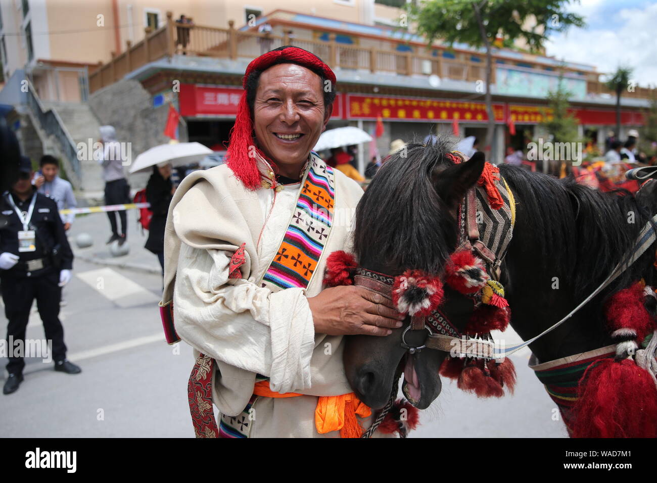 An entertainer dressed in Kangba costumes, one branch of the Tibetan ...