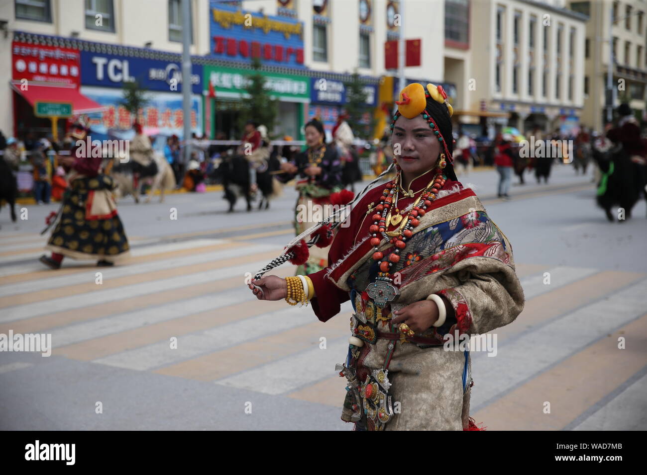 An entertainer dressed in Kangba costumes, one branch of the Tibetan ...