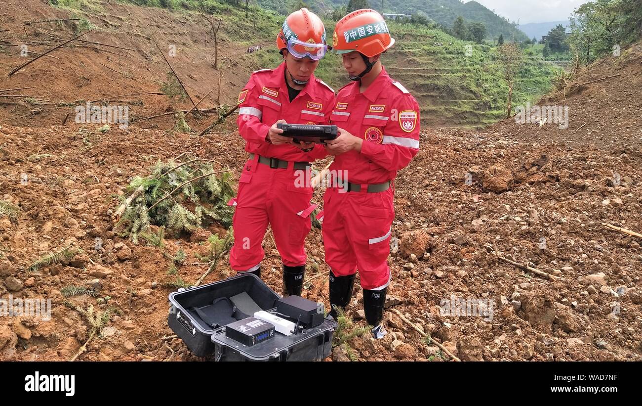 Chinese rescuer search for victims and survivors after a landslide ...