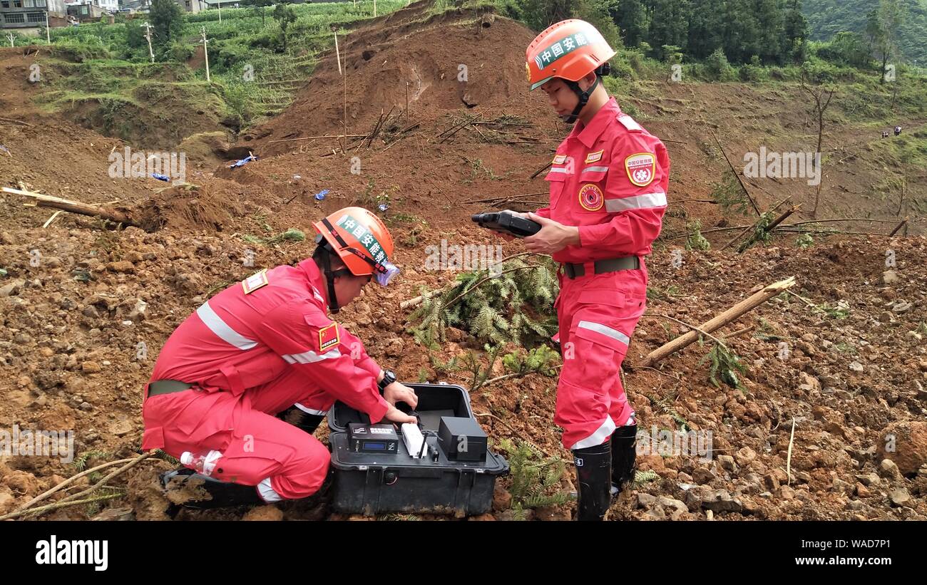 Chinese rescuer search for victims and survivors after a landslide ...