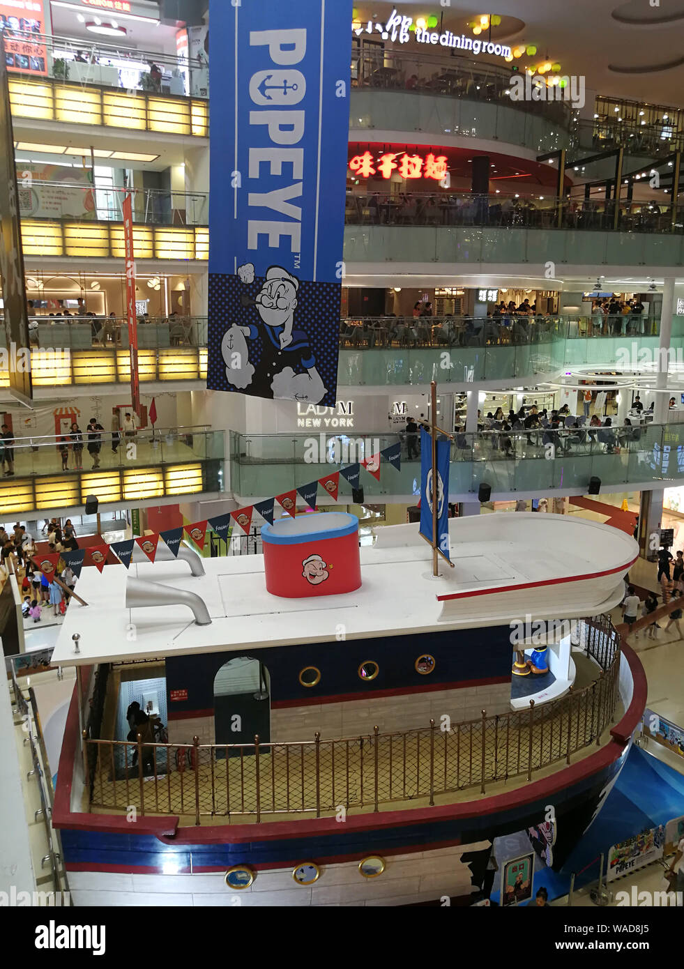 Customers view sculptures featuring cartoon character "Popeye the ...