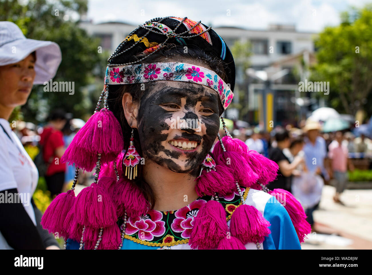 Chinese people of the Yi ethnic group daub their faces black to ...