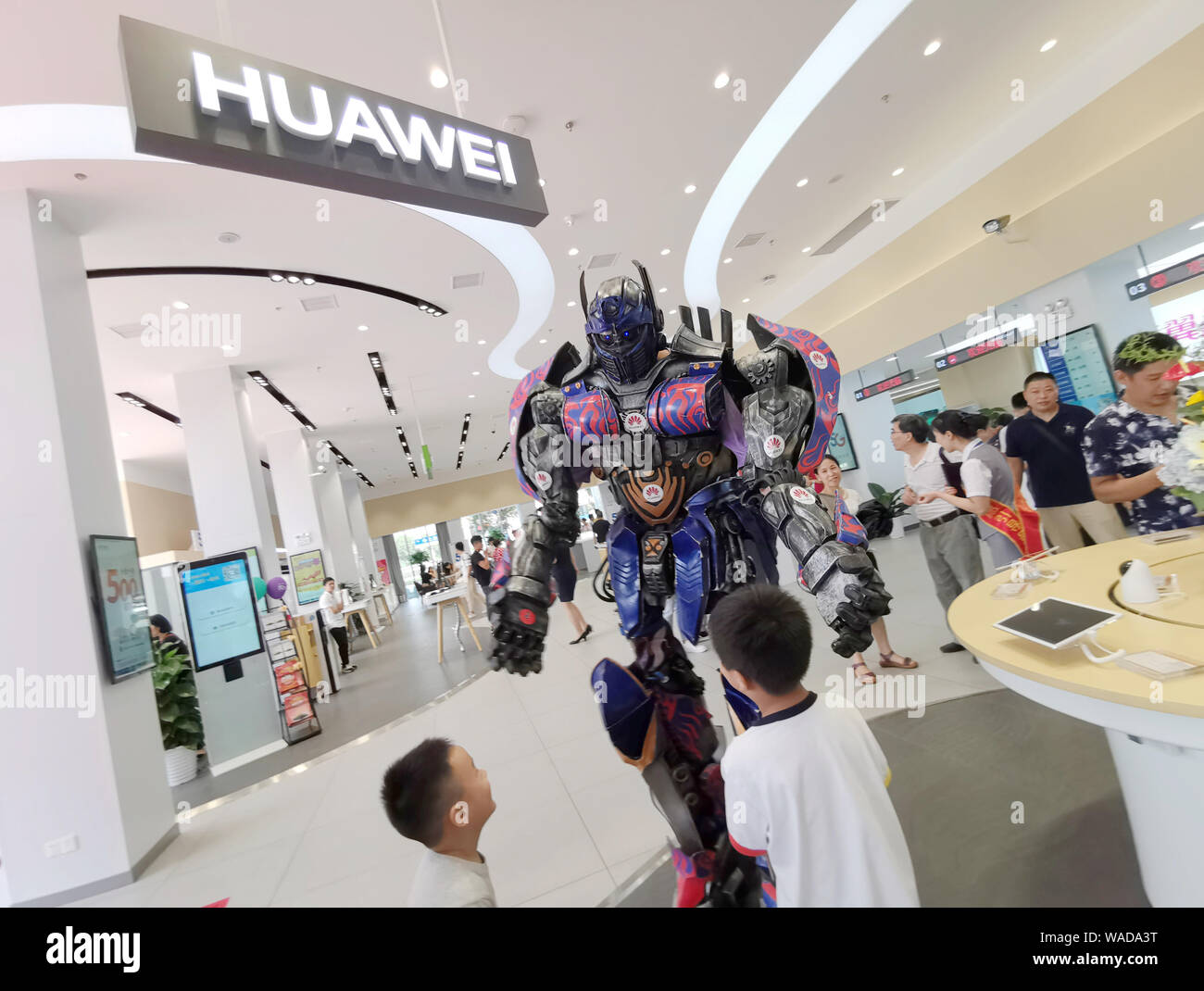 --FILE--A performer dressed in his Transformers costume interacts with ...
