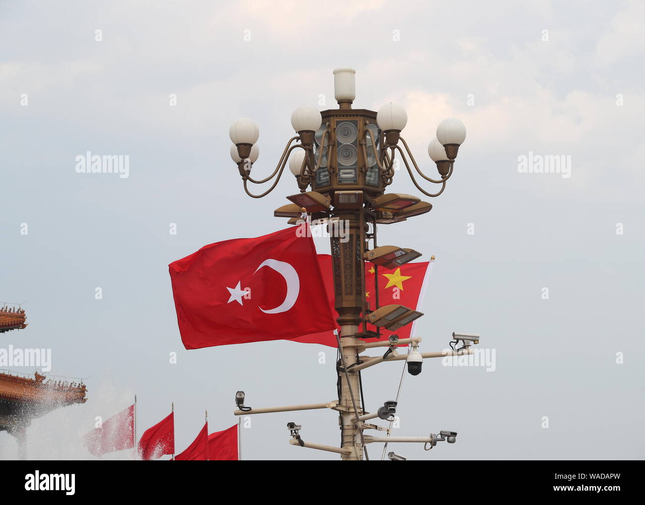 National flags of China and Turkey flutter on a lamppost in front of ...