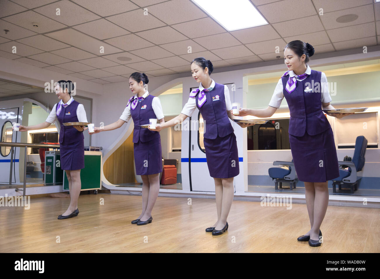Chinese high-speed train attendants pose during a training session in ...