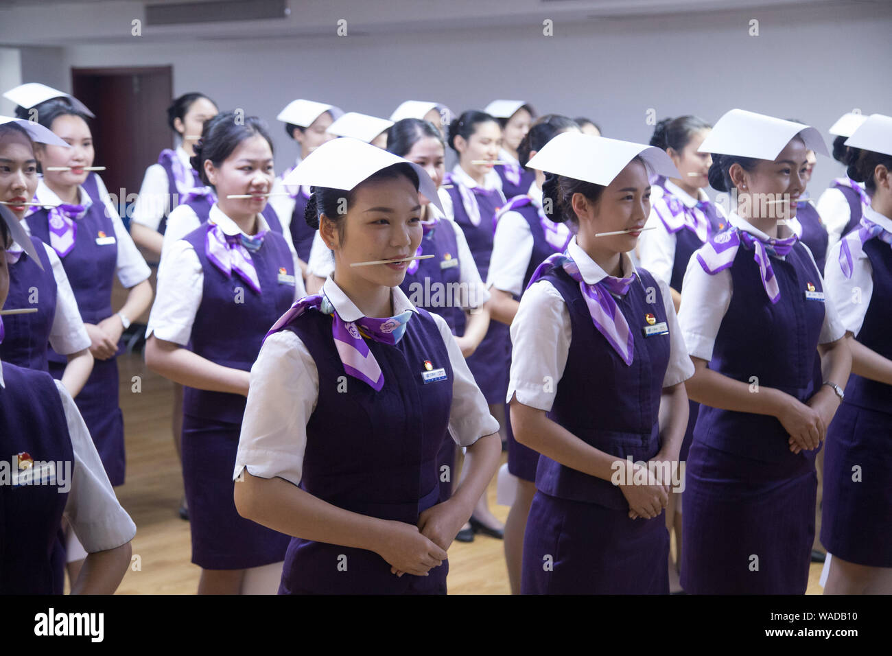 Chinese high-speed train attendants bite chopsticks to practice smiling ...
