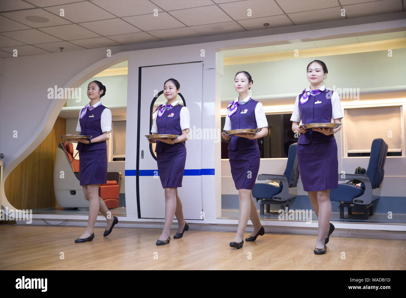 Chinese high-speed train attendants pose during a training session in ...