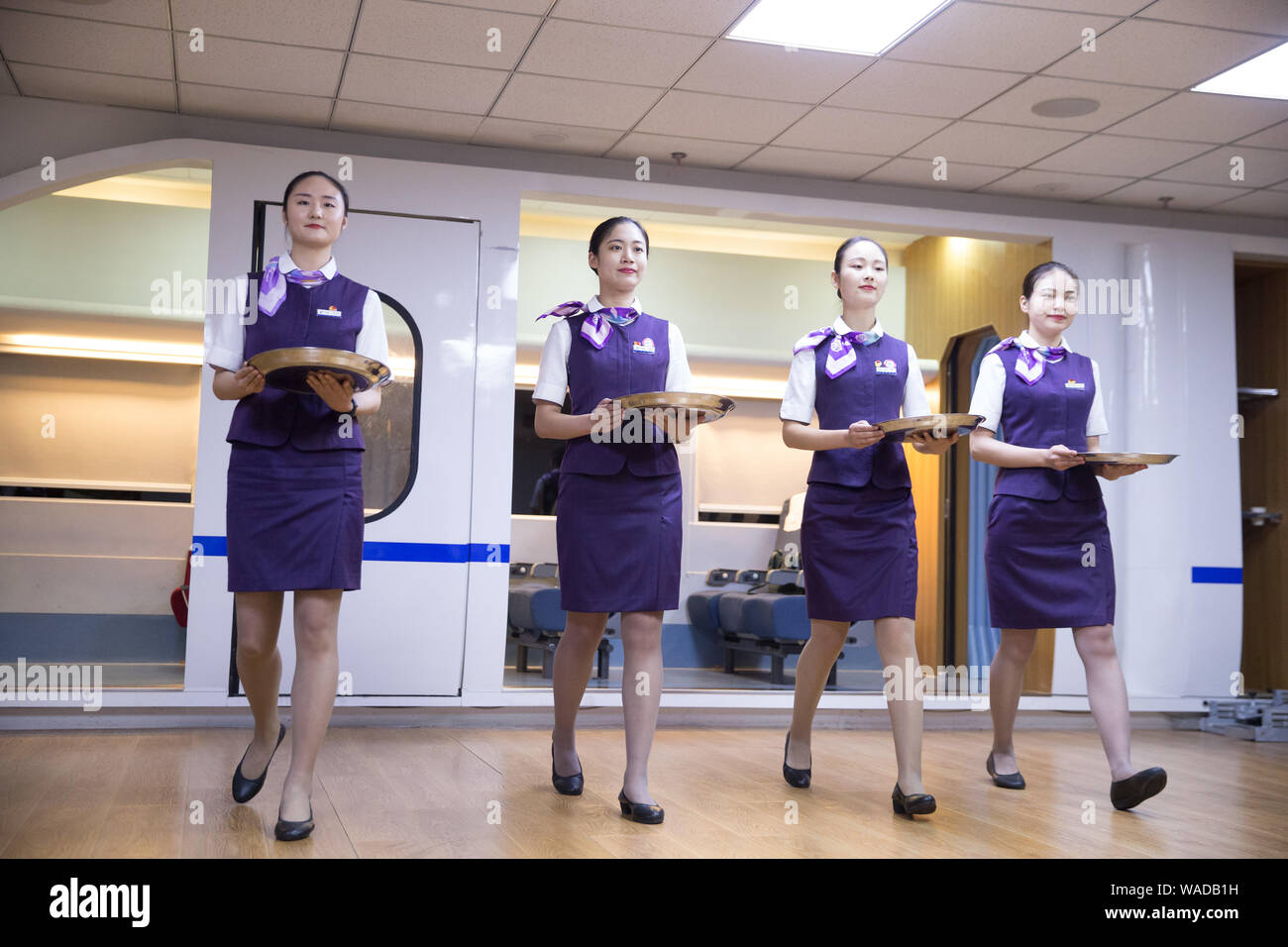 Chinese high-speed train attendants pose during a training session in ...