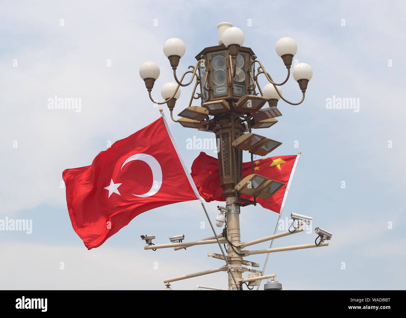 National flags of China and Turkey flutter on a lamppost in front of ...