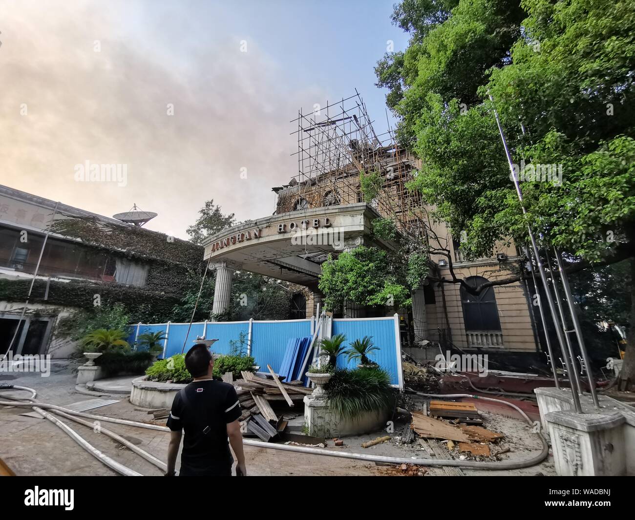 Chinese firefighters spray water to distinguish the fire after a fire ...