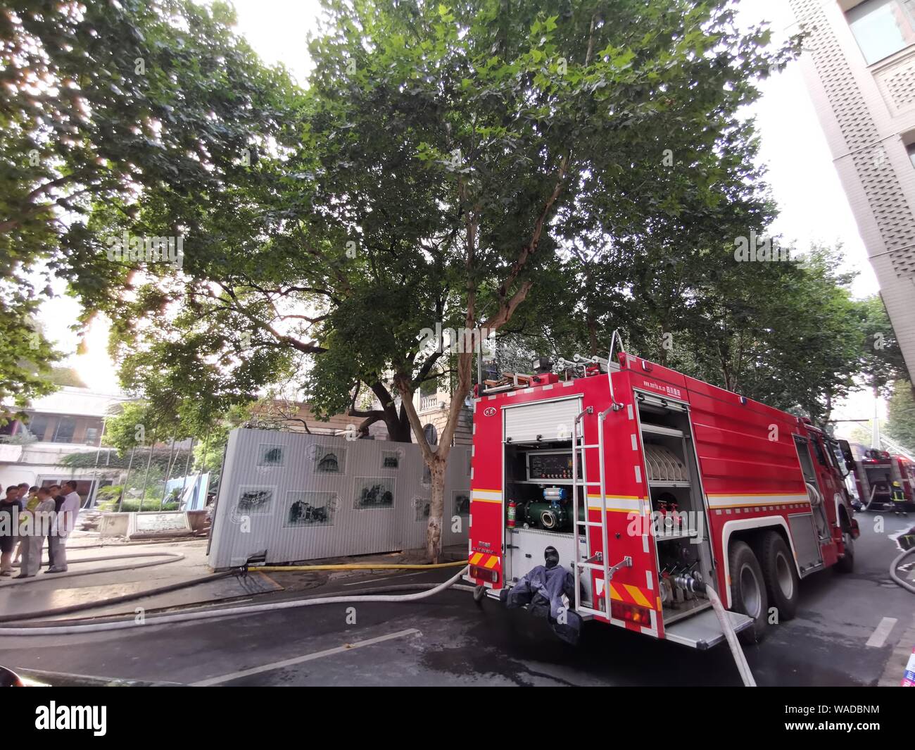 Chinese firefighters spray water to distinguish the fire after a fire ...