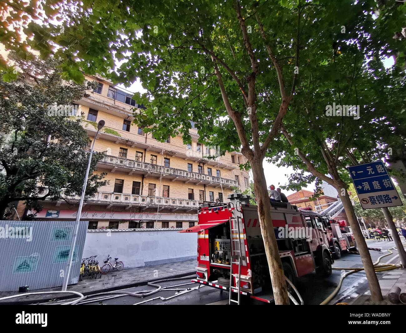 Chinese firefighters spray water to distinguish the fire after a fire ...
