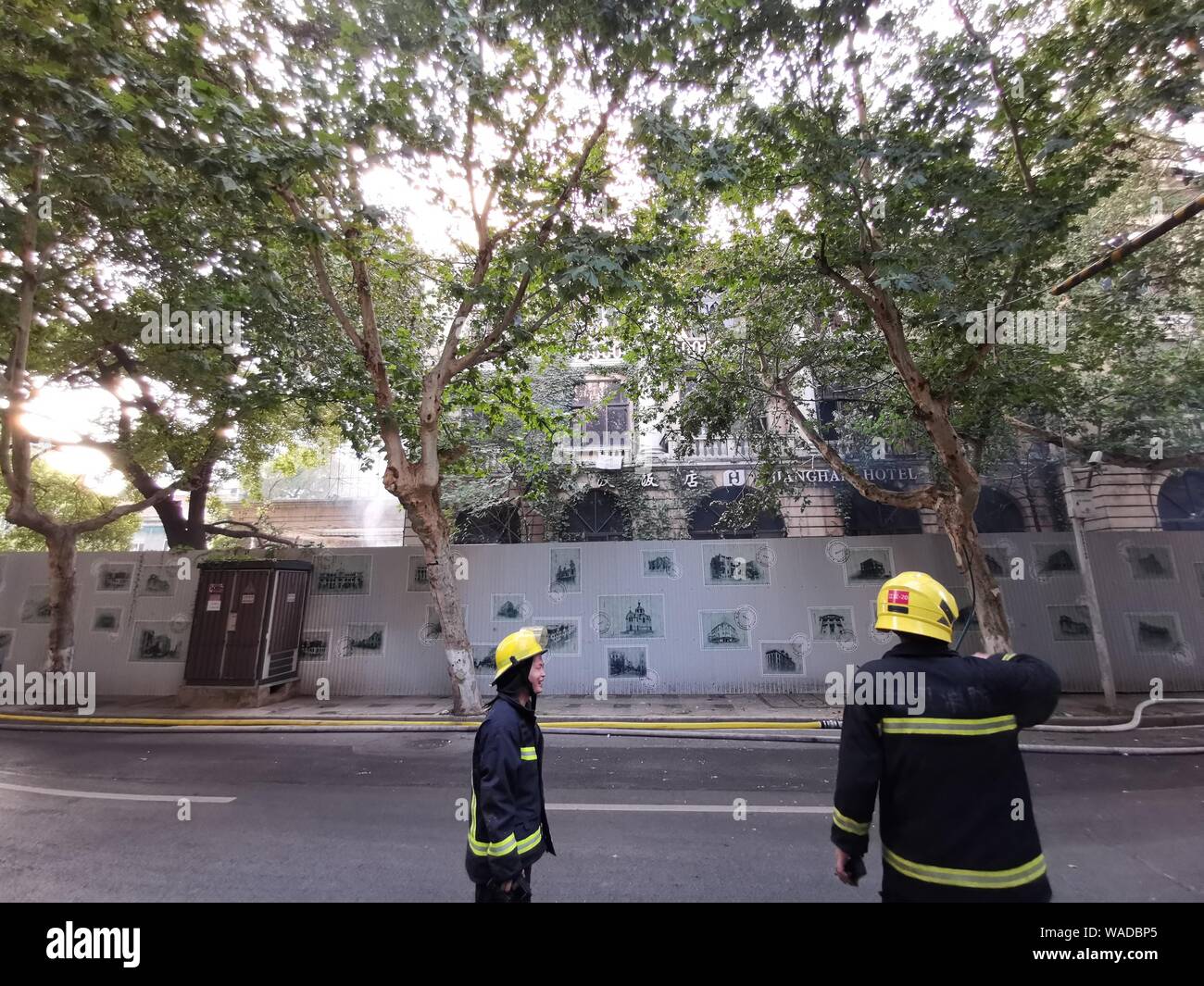 Chinese firefighters spray water to distinguish the fire after a fire ...