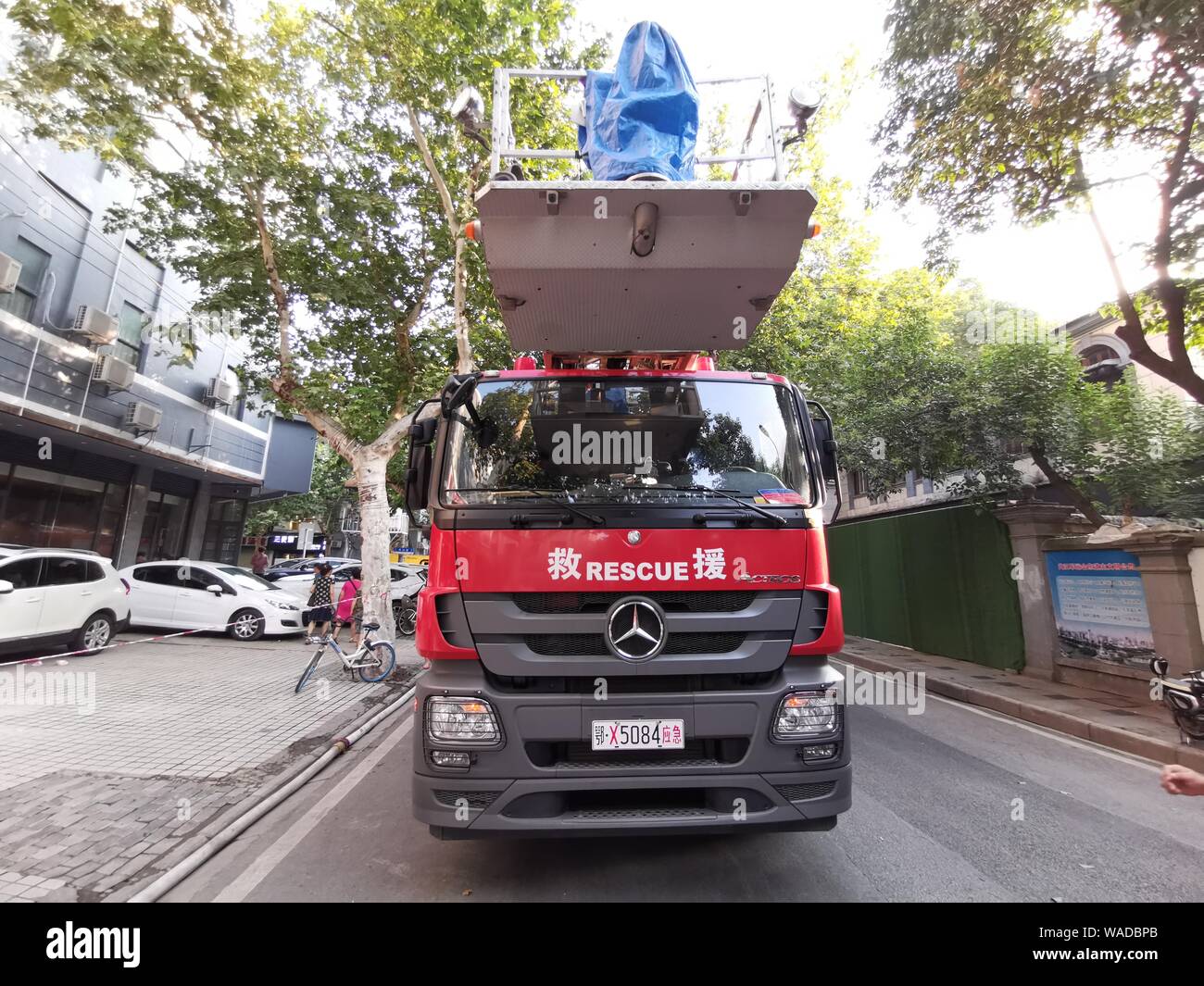 Chinese firefighters spray water to distinguish the fire after a fire ...