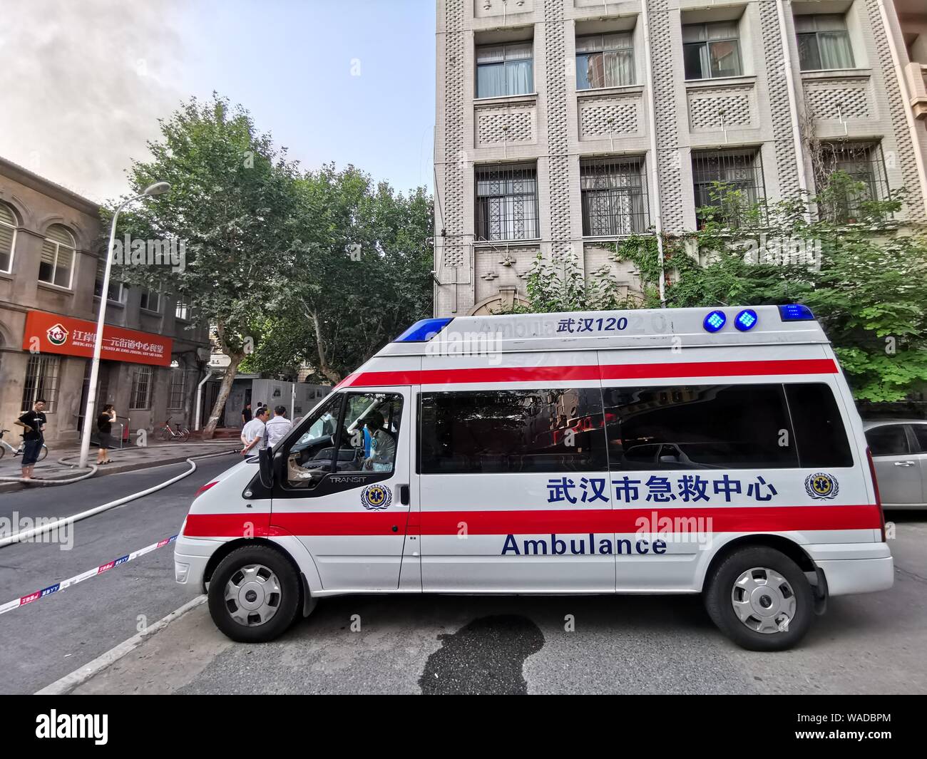 Chinese firefighters spray water to distinguish the fire after a fire ...