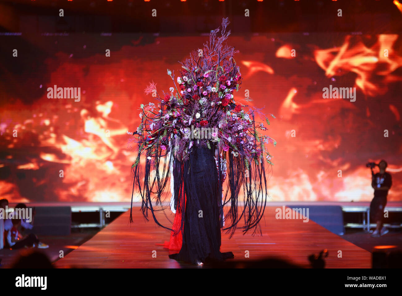 A model displays a new creation decorated with flowers at a floral ...