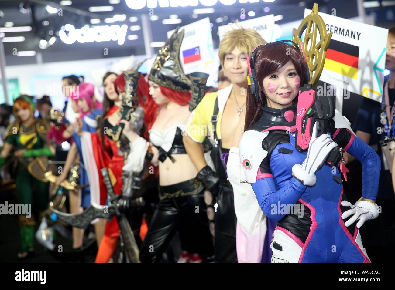 Young girls and boys dressed in cosplay costumes pose during the WCG 2019 finals in Xi'an city ...