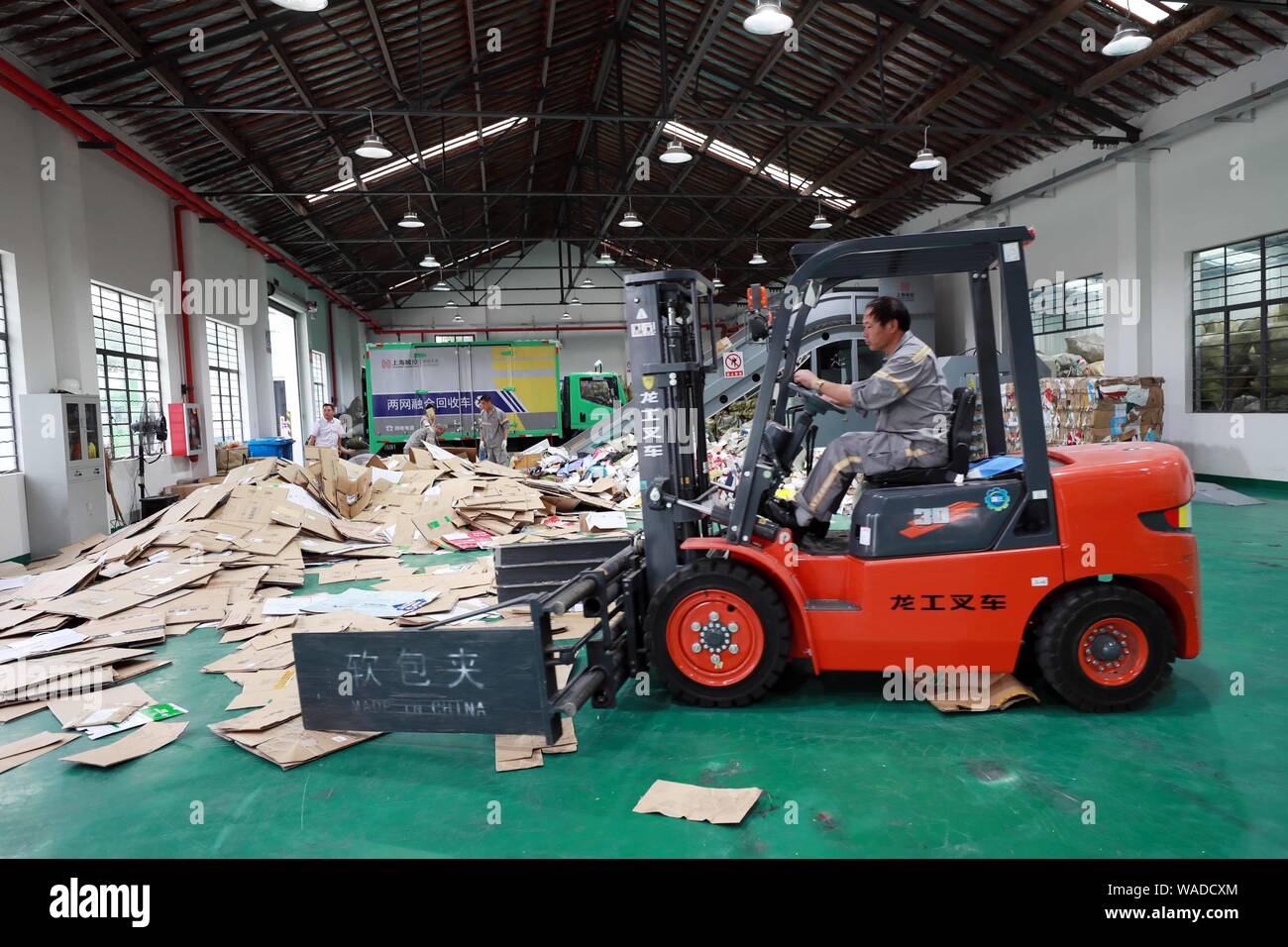 A Chinese worker sorts out recycling waste at a distribution center of ...