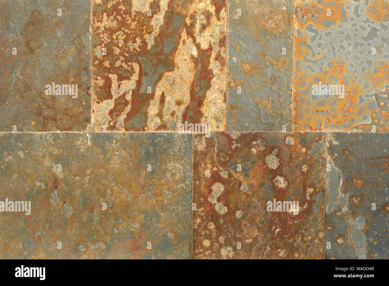 Rust colored square flagstones on a wall. Texture detail close up Stock ...