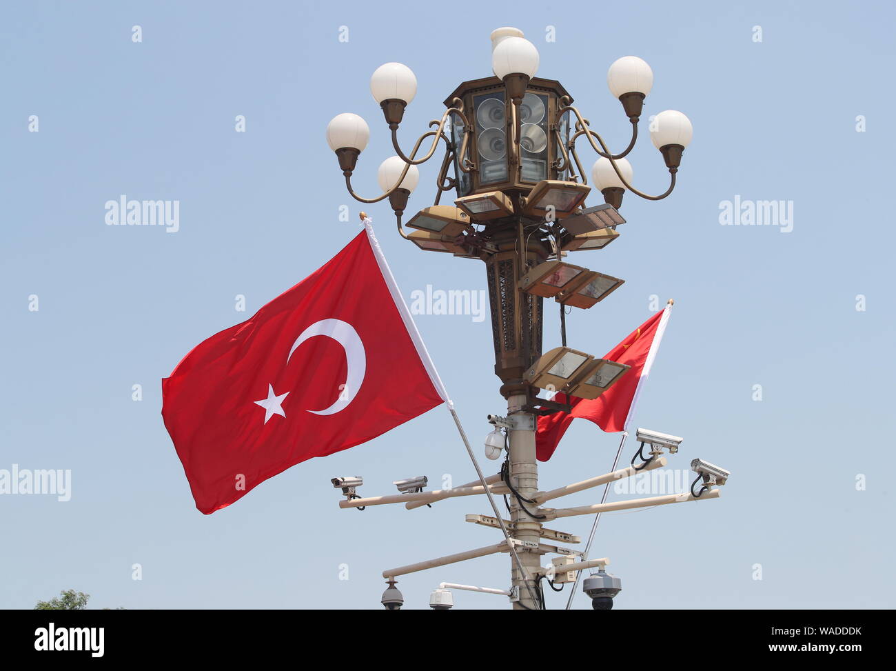 National flags of China and Turkey flutter on a lamppost in front of ...