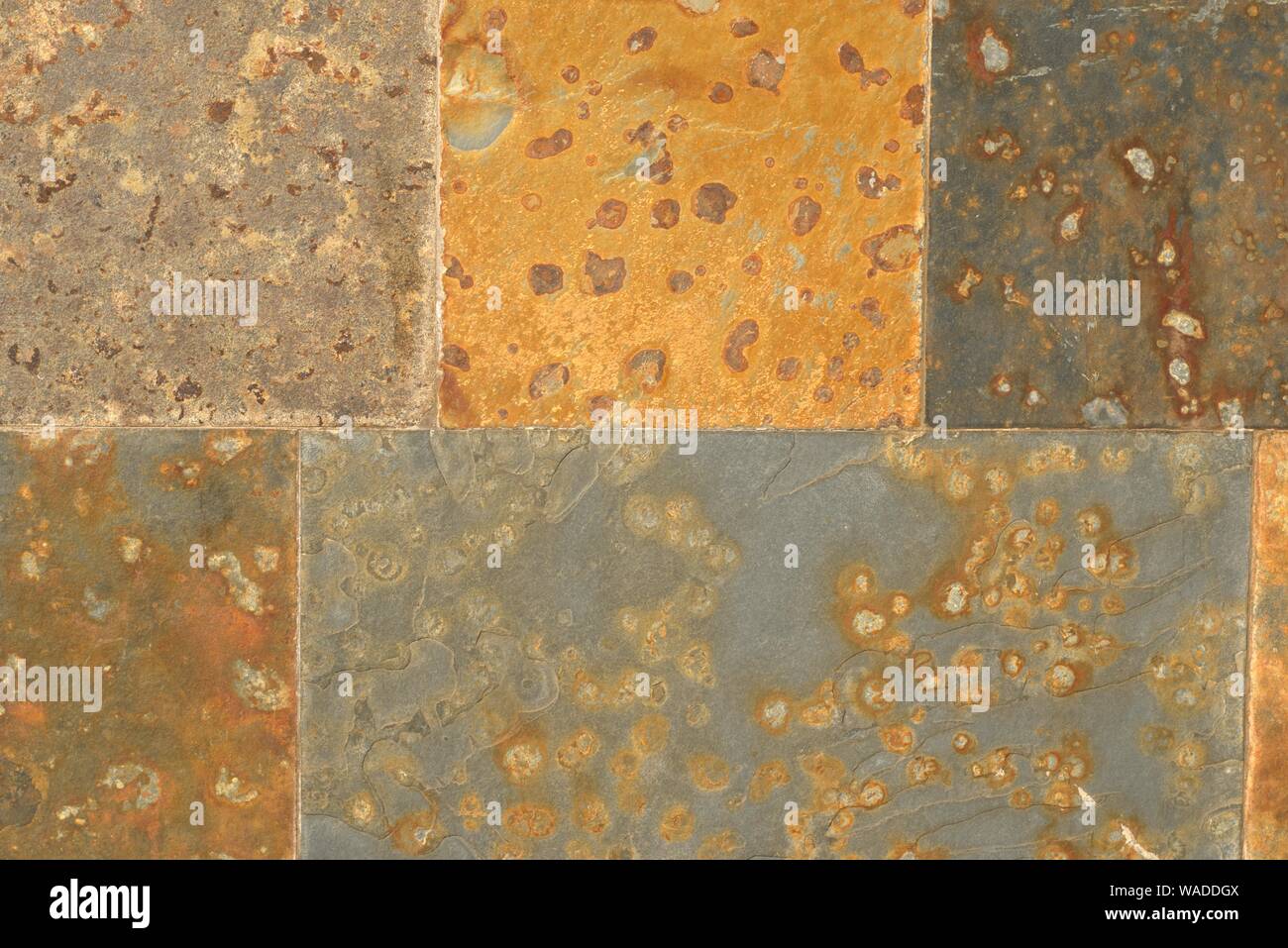 Rust colored square flagstones on a wall. Texture detail close up Stock ...