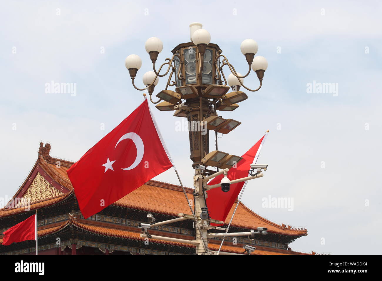 National flags of China and Turkey flutter on a lamppost in front of ...