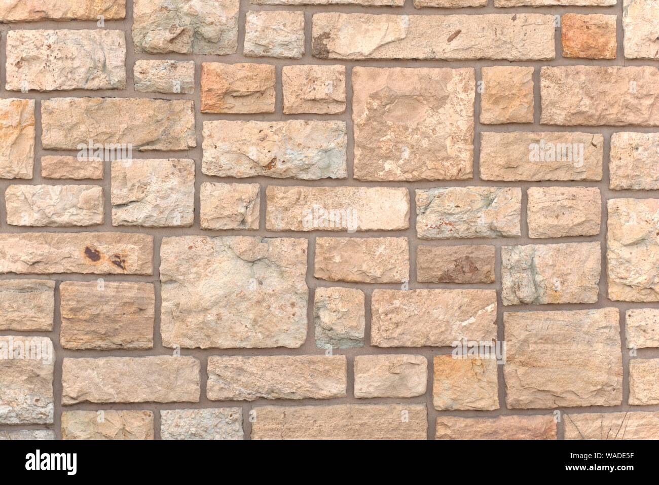 Untreated stone wall, pattern of square stones. Texture detail Stock ...