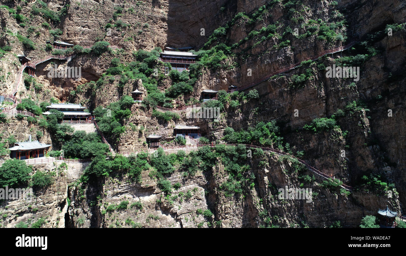 A total of 28 ancient Taoist temples built on the cliff are seen in ...