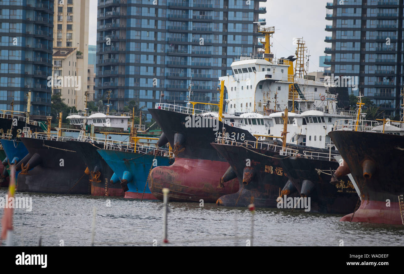 Fishing boats are docked at a harbor in preparation for Typhoon Wipha ...