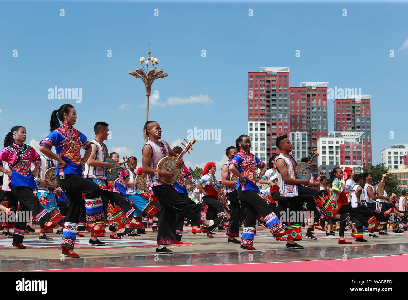 Chinese people of the Yi ethnic group daub their faces black to ...